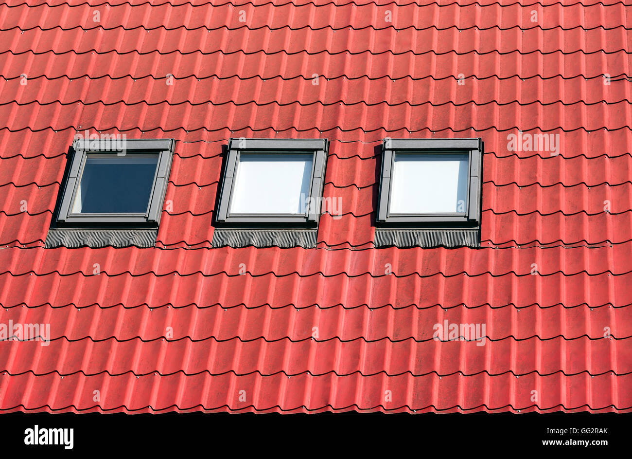 New orange tiled roof with three garret windows Stock Photo - Alamy
