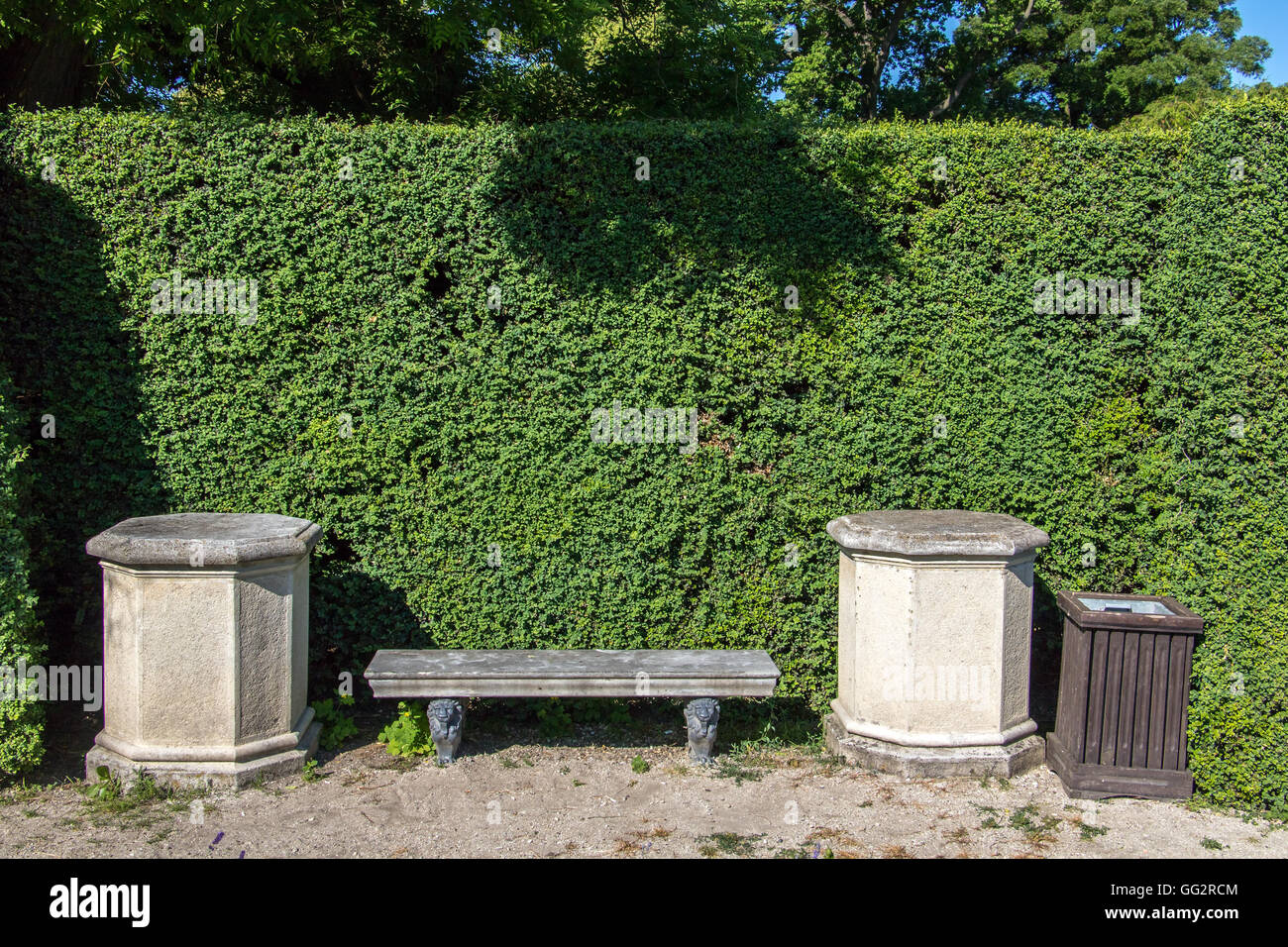 stone bench in the park with green hedgerow Stock Photo - Alamy
