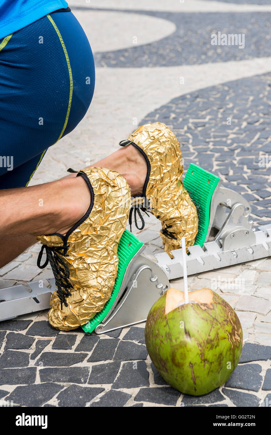 Brazilian athlete wearing flip flops crouching at the start position in ...
