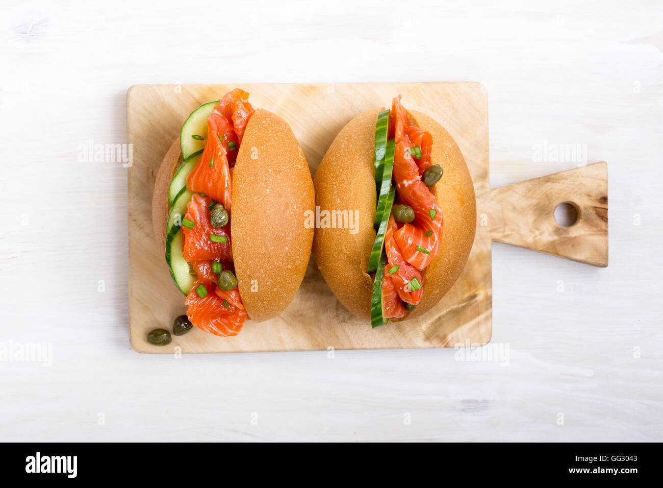 Smoked salmon bun sandwich with cucumber and capers, top view Stock ...