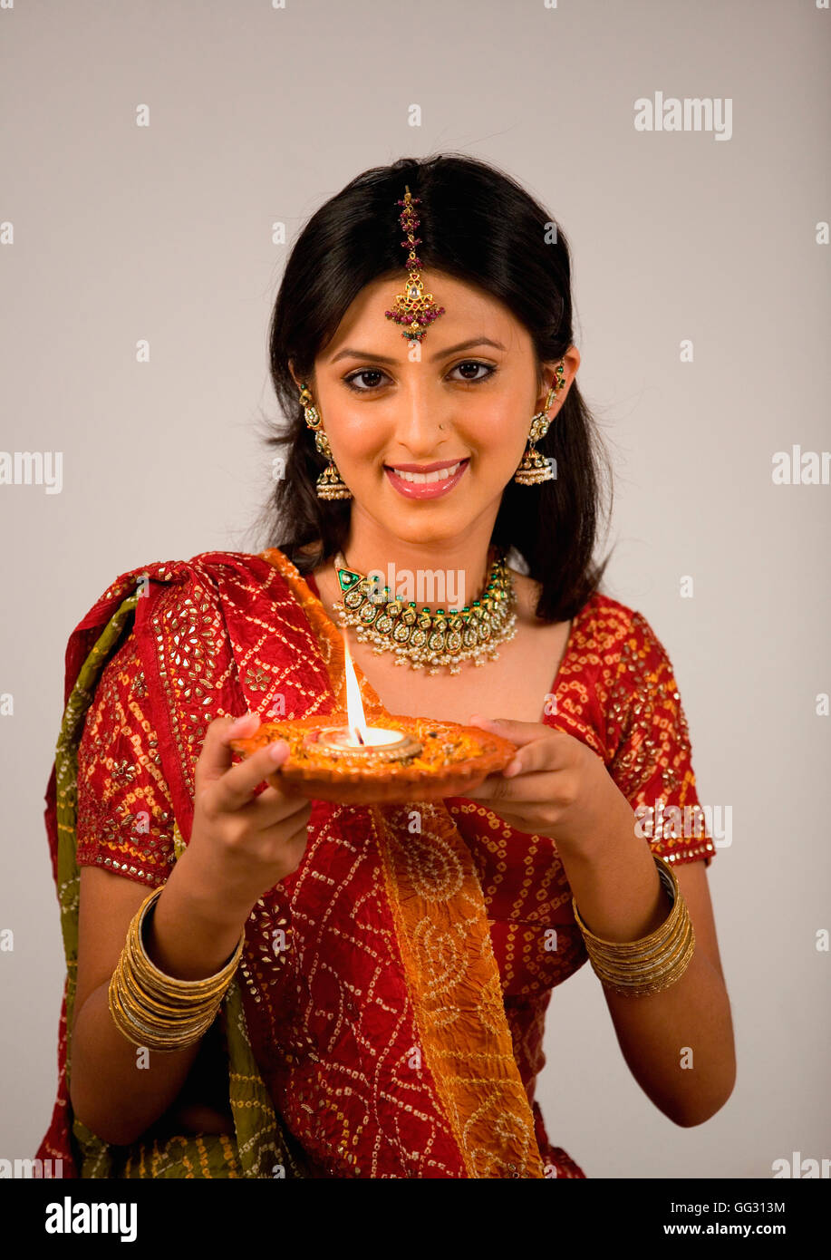 Lady holding diya hi-res stock photography and images - Alamy