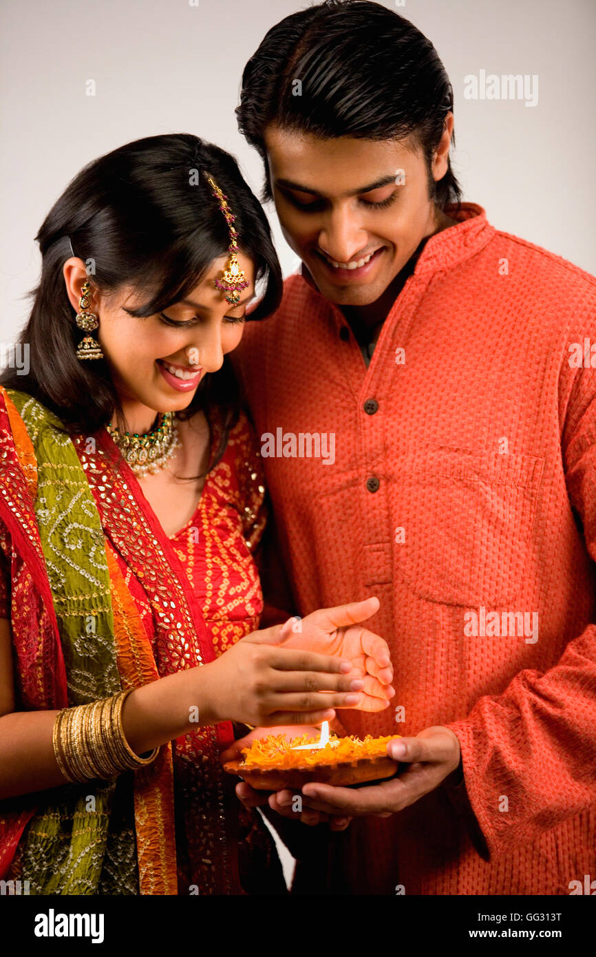 Couple holding Diya Stock Photo - Alamy