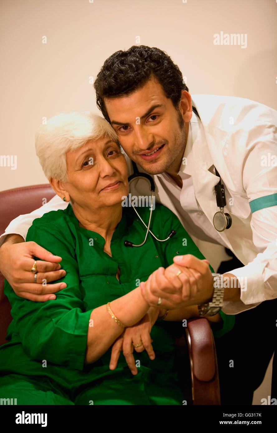 Young doctor comforting his patient Stock Photo - Alamy