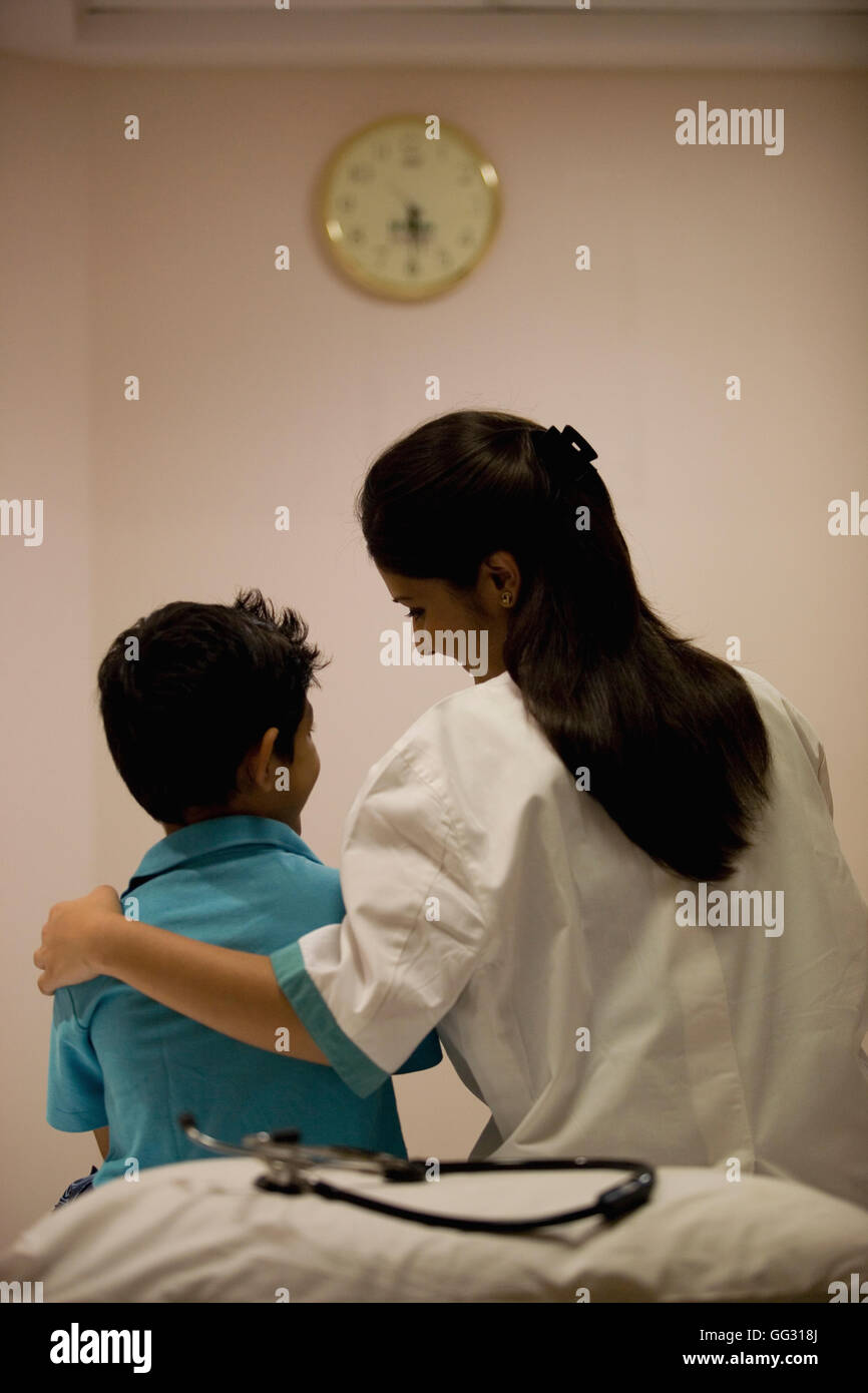 Doctor comforting her patient Stock Photo - Alamy