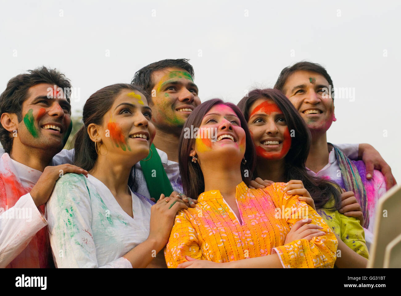 Friends celebrating Holi Stock Photo - Alamy