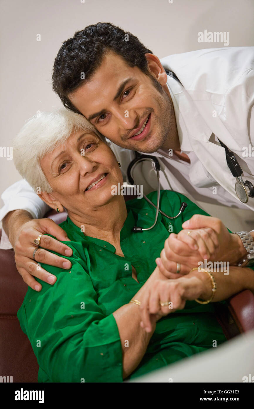 Young doctor comforting his patient Stock Photo - Alamy
