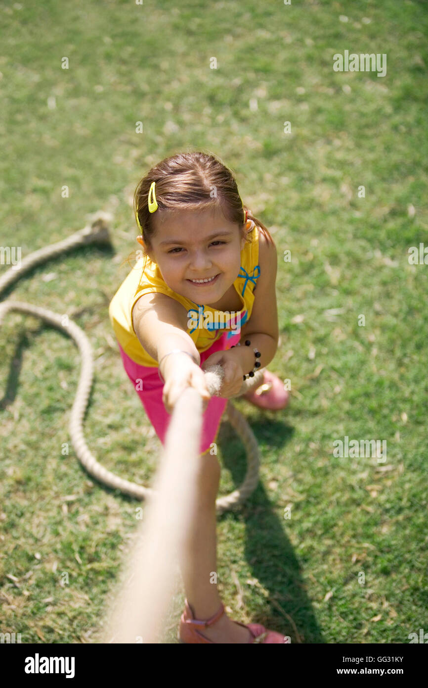 Girl pulling a rope Stock Photo - Alamy