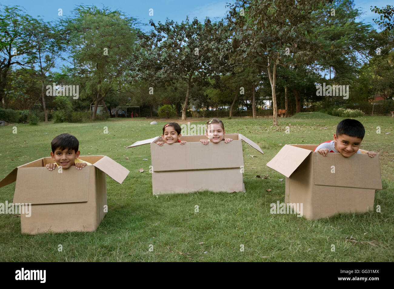 Children sitting in boxes Stock Photo - Alamy