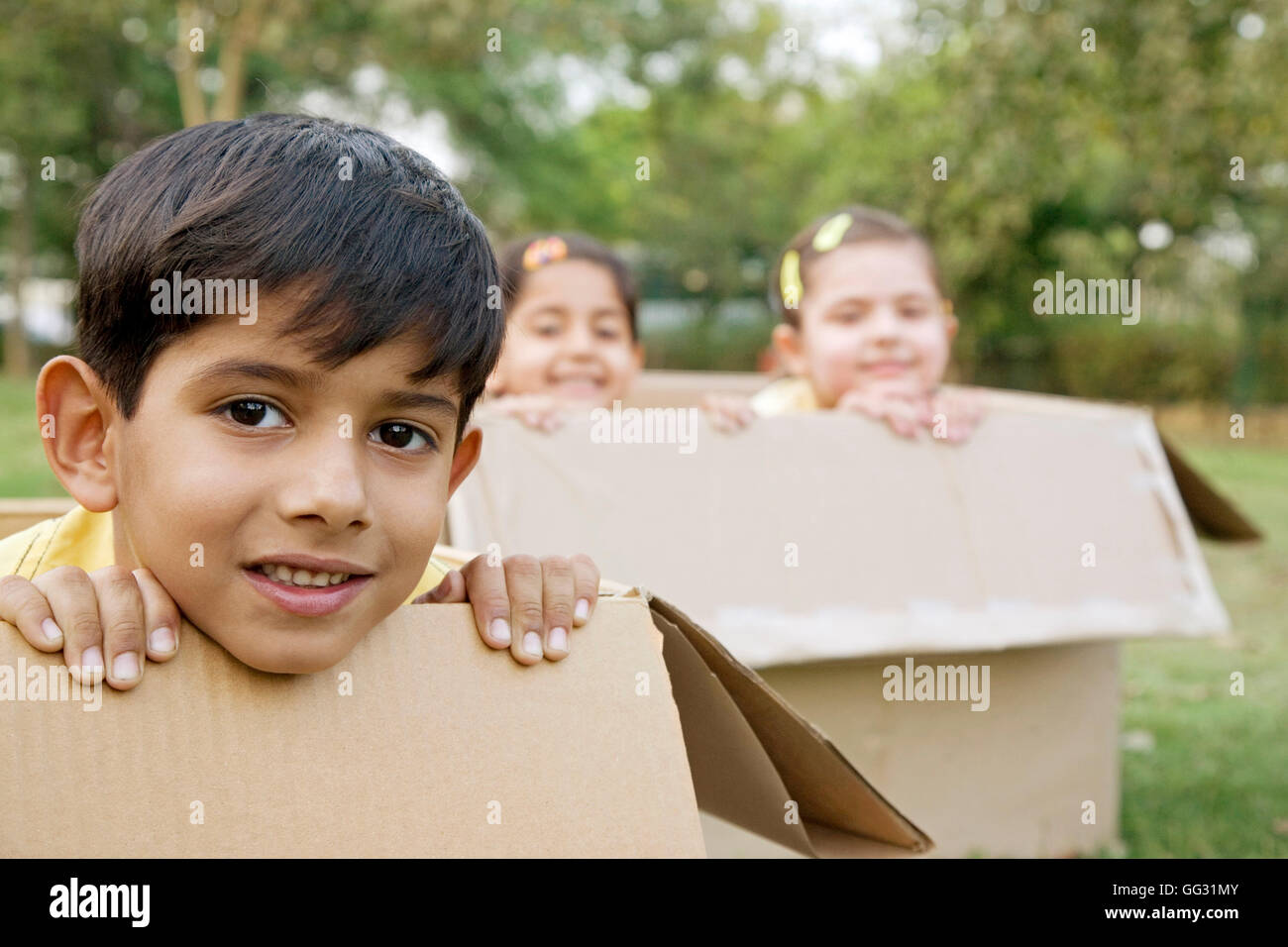 Children sitting in boxes Stock Photo - Alamy