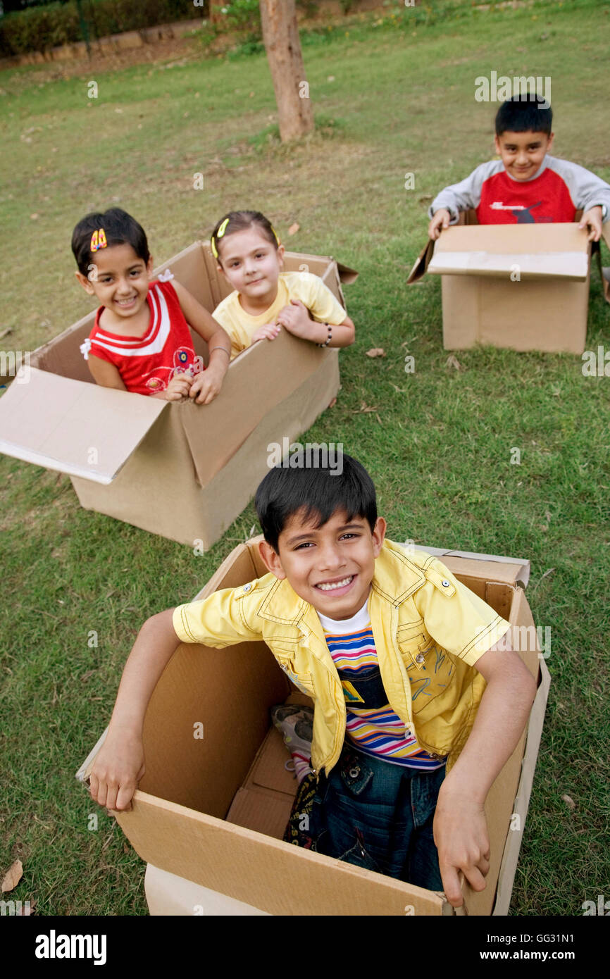 Children sitting in boxes Stock Photo - Alamy