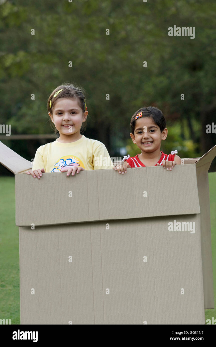 Girls standing inside a box Stock Photo - Alamy