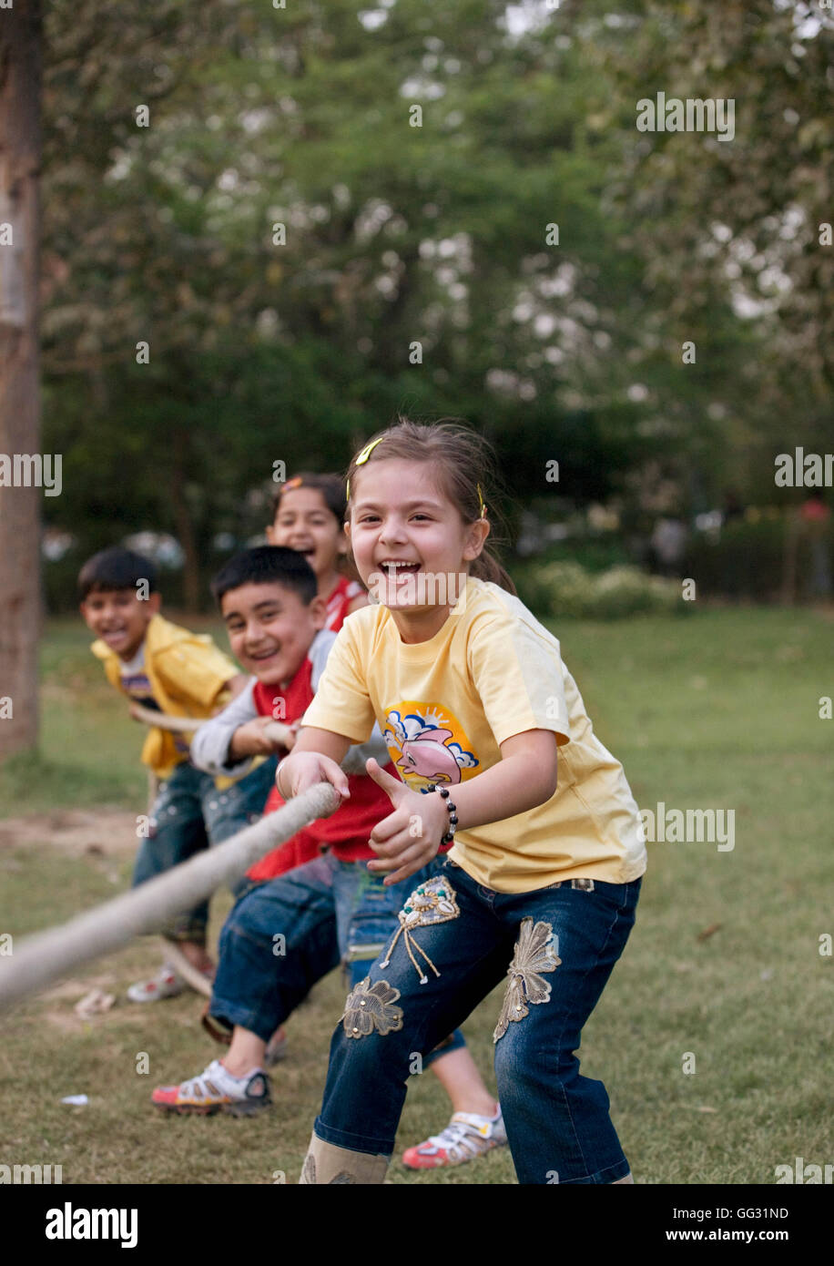 Children pulling a rope Stock Photo - Alamy