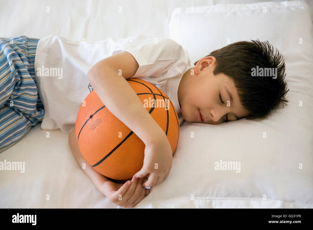 Boy sleeping with a basket ball Stock Photo - Alamy