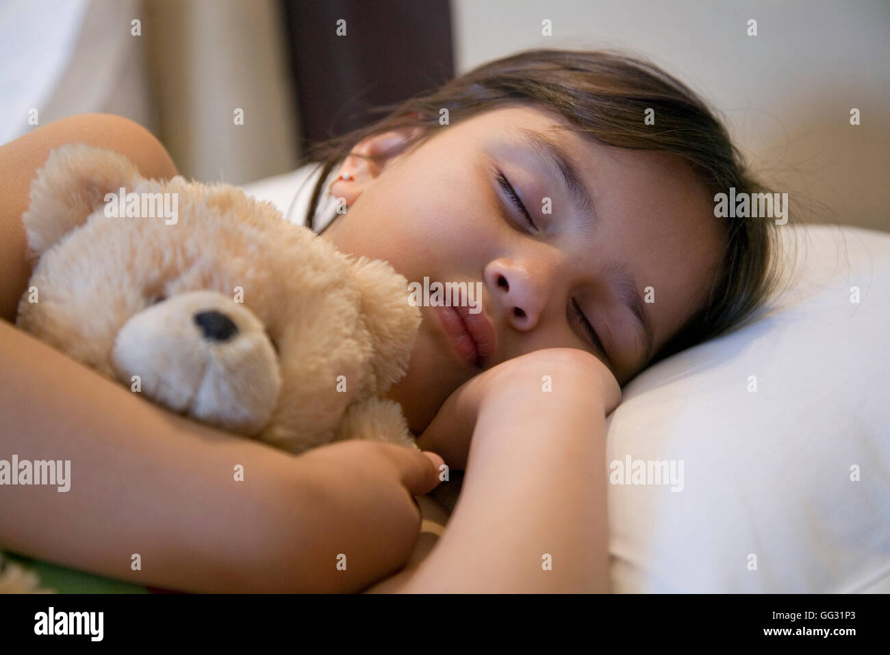 Girl sleeping with a stuffed toy Stock Photo - Alamy