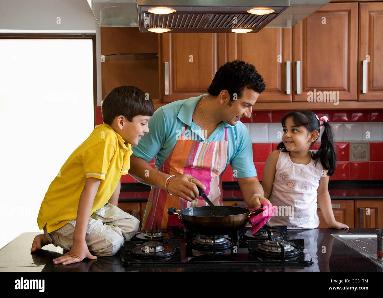 Indian father and son cooking hi-res stock photography and images - Alamy