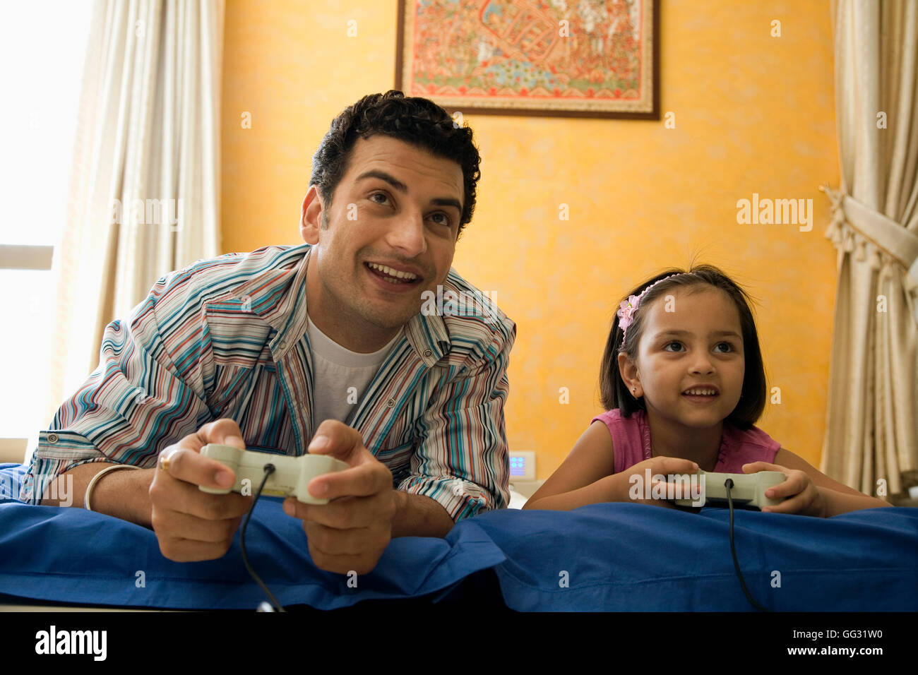 Father and daughter playing video games Stock Photo - Alamy