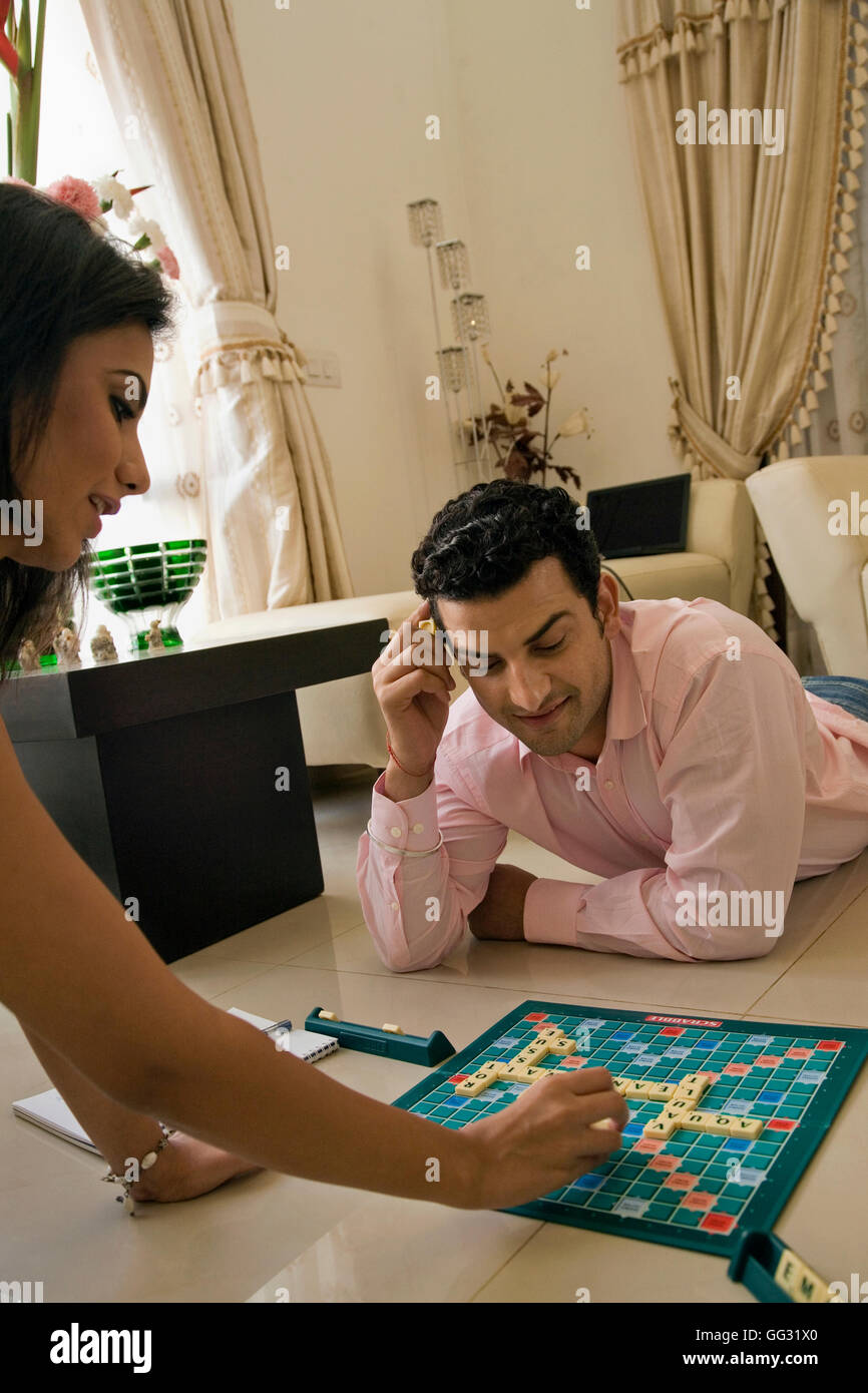 Couple playing scrabble Stock Photo - Alamy