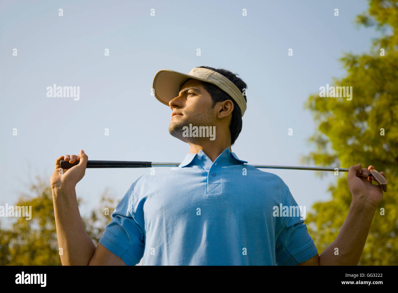 Golfer with a club Stock Photo - Alamy