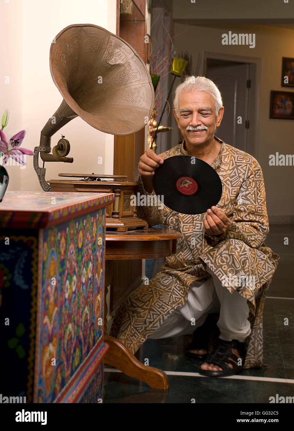 Old man holding a record Stock Photo - Alamy