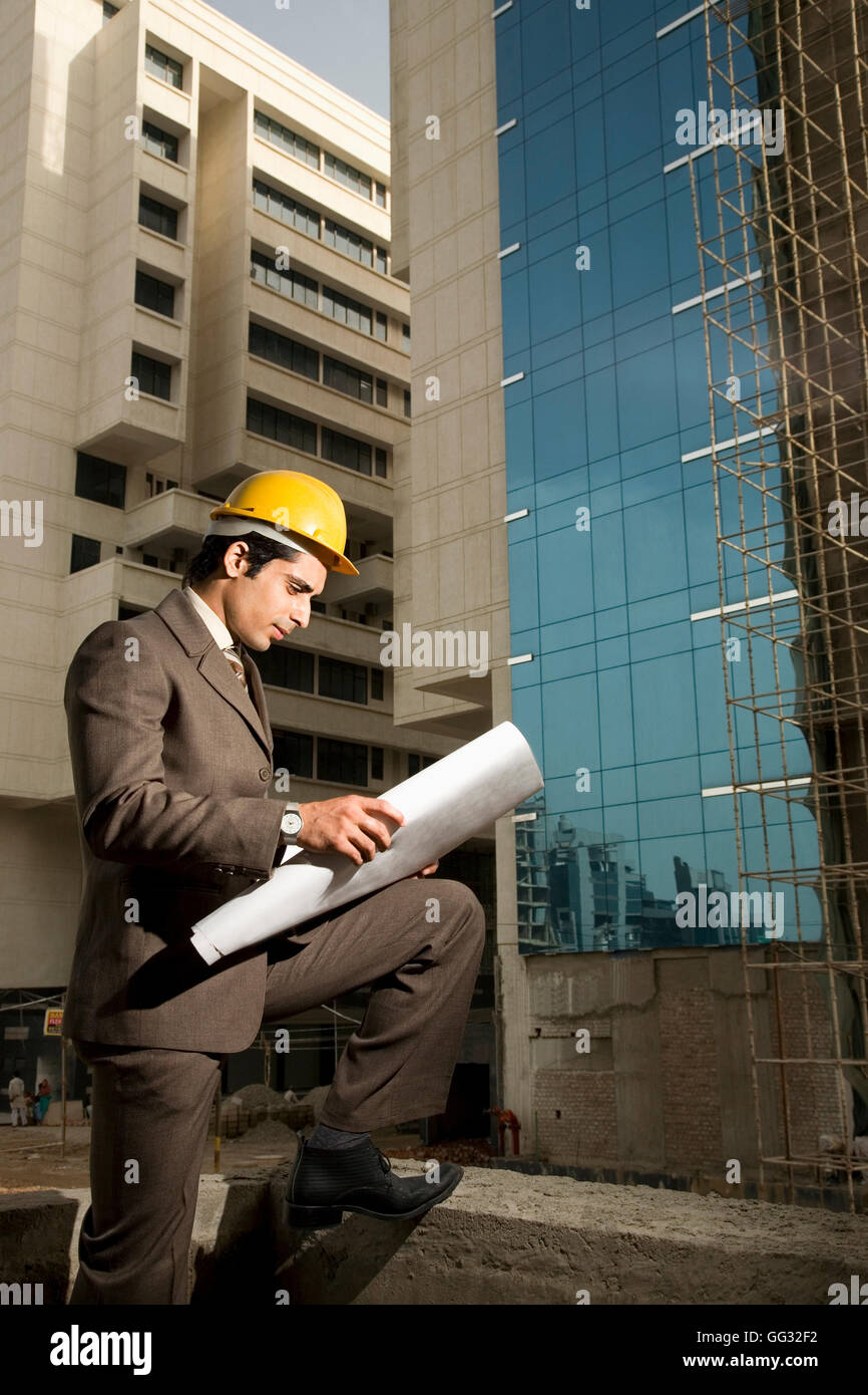 Engineer looking at blueprints Stock Photo - Alamy