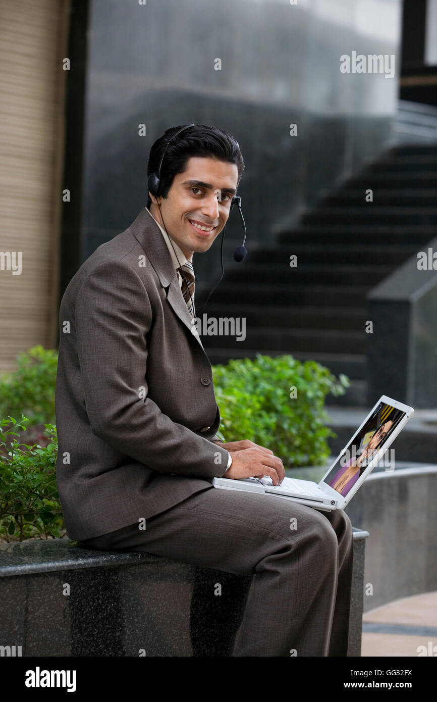 Executive working on his laptop Stock Photo - Alamy