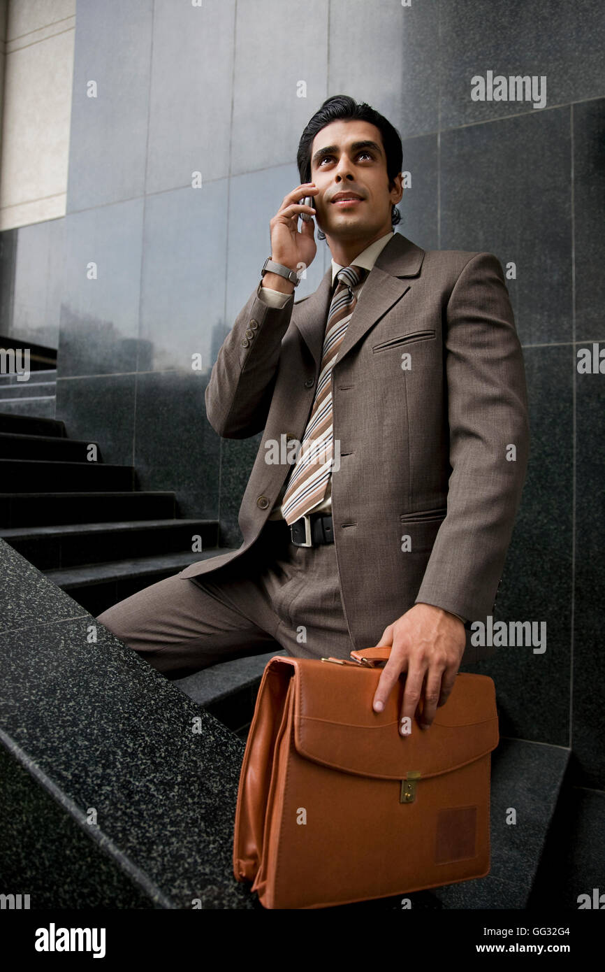 Executive talking on his phone Stock Photo - Alamy