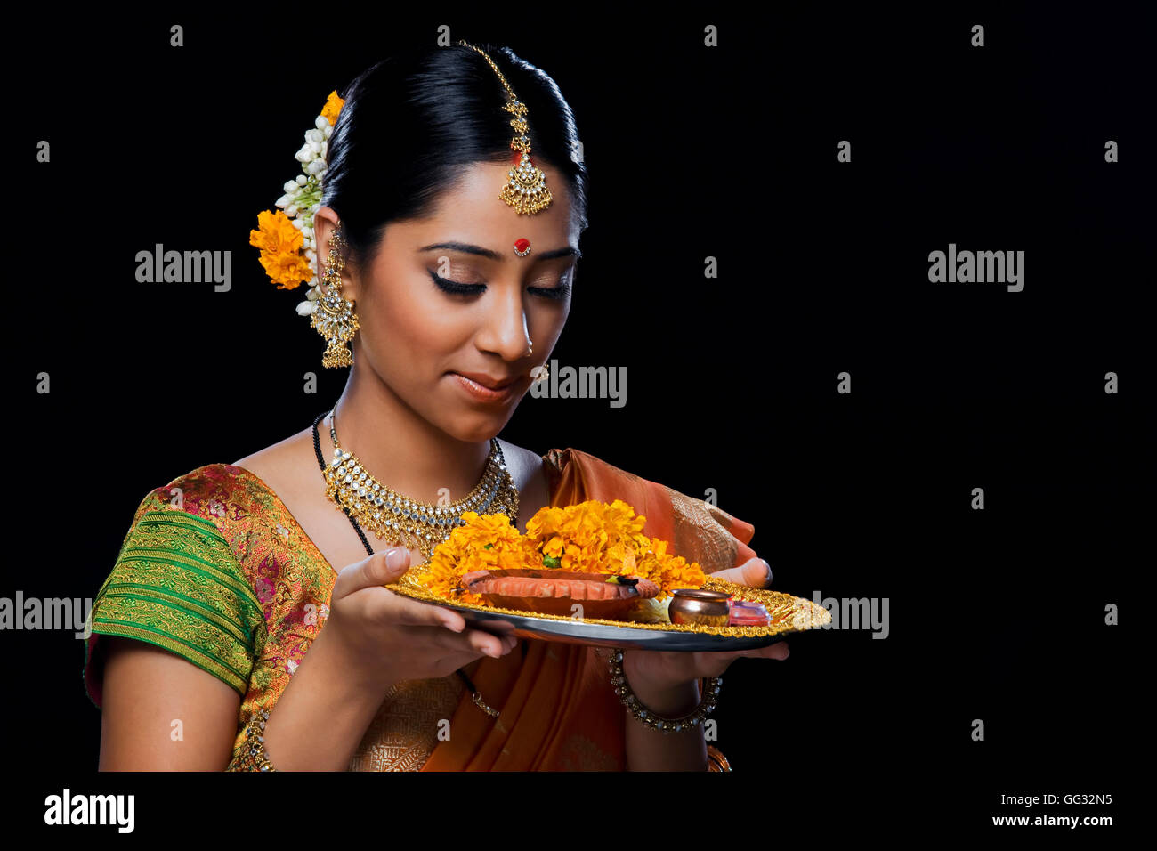Indian woman performing puja Stock Photo - Alamy