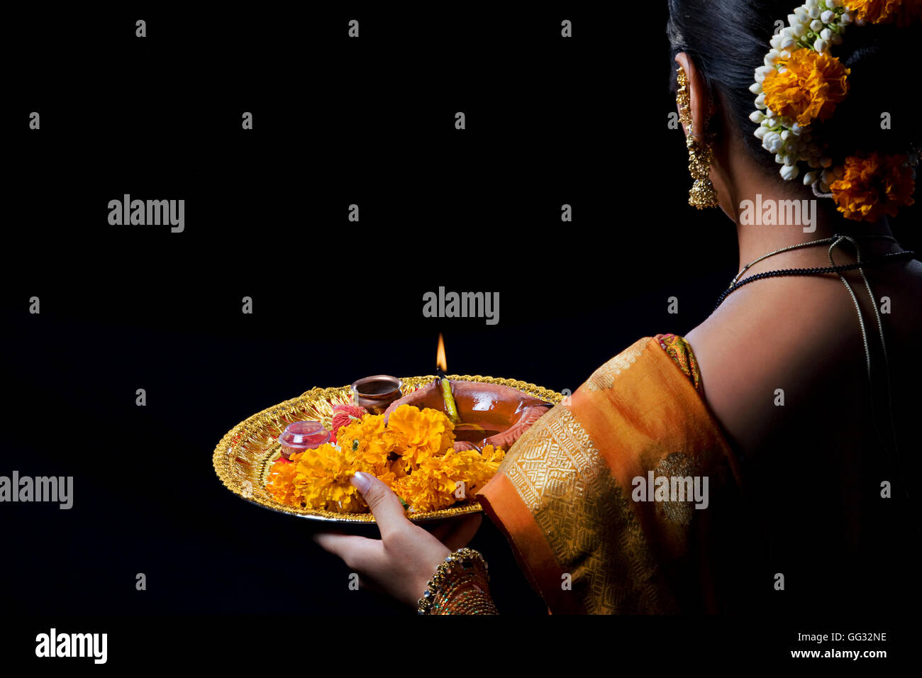 Indian woman performing puja Stock Photo - Alamy