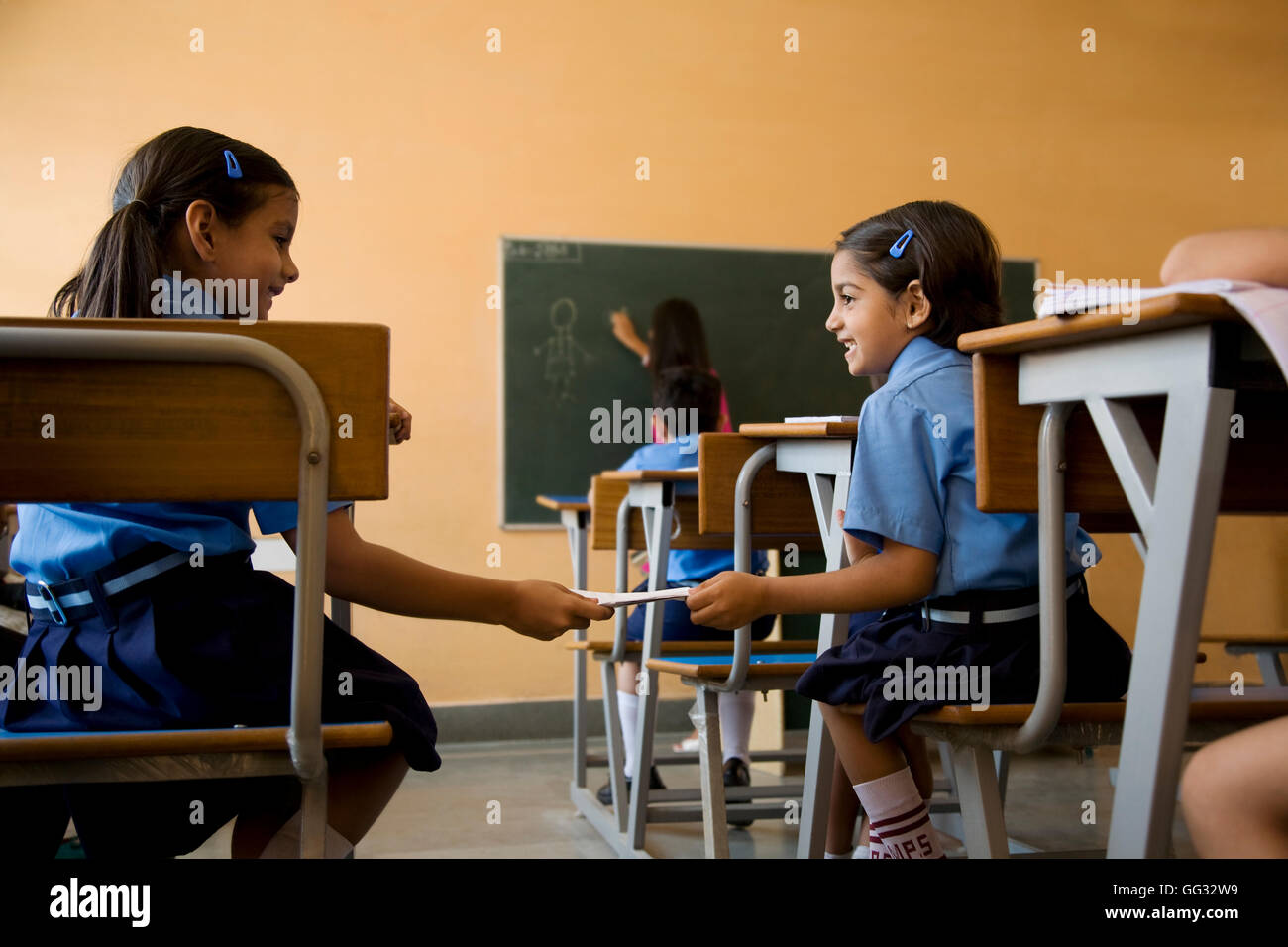 School girls exchanging a notebook Stock Photo - Alamy