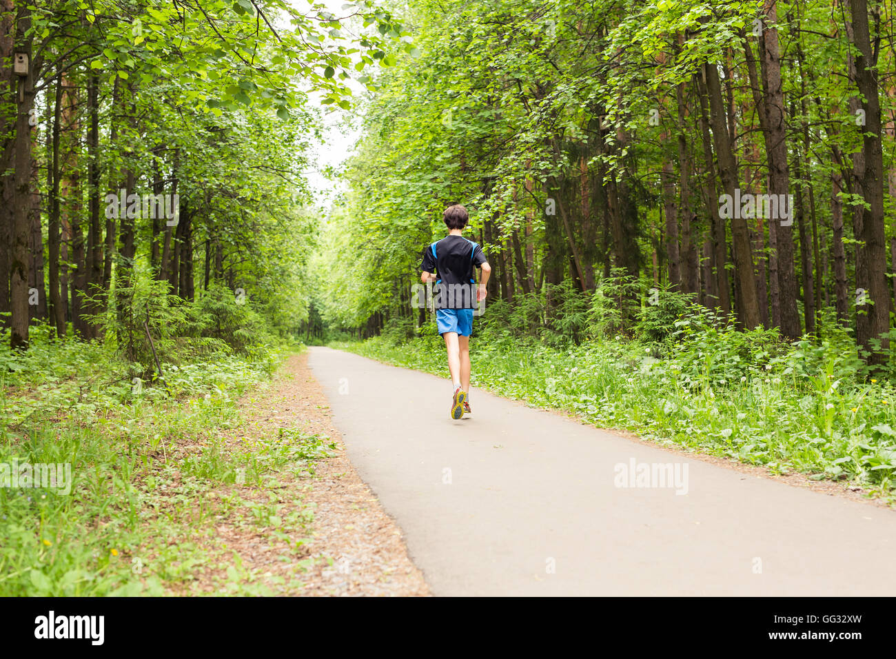 Athletic young man running in the nature. Healthy lifestyle Stock Photo ...