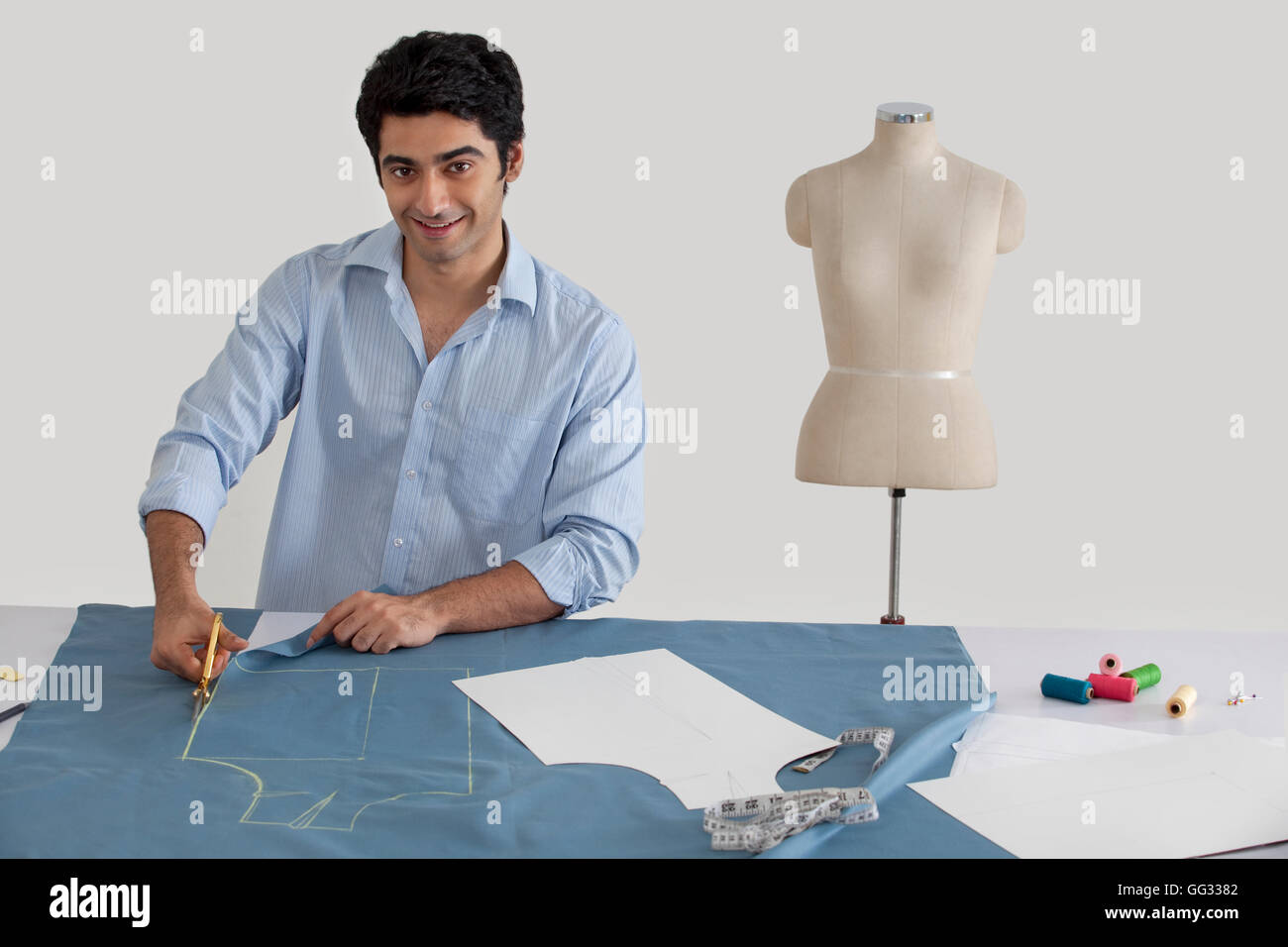 Fashion designer working in fashion studio Stock Photo - Alamy