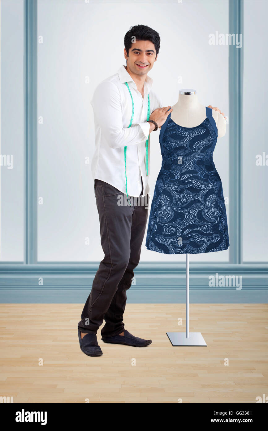 Male fashion designer standing by mannequin Stock Photo - Alamy