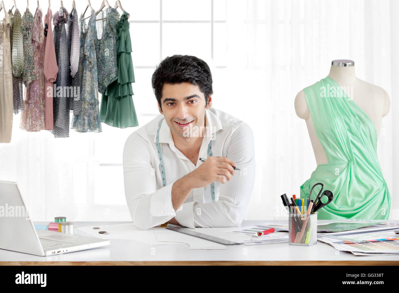 Handsome male fashion designer smiling in studio Stock Photo - Alamy