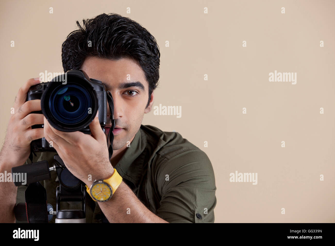 Close-up of young male photographer taking a photograph Stock Photo - Alamy