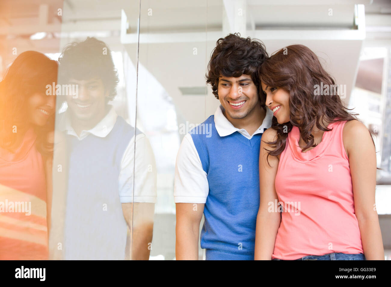 Young couple looking at window display together Stock Photo - Alamy