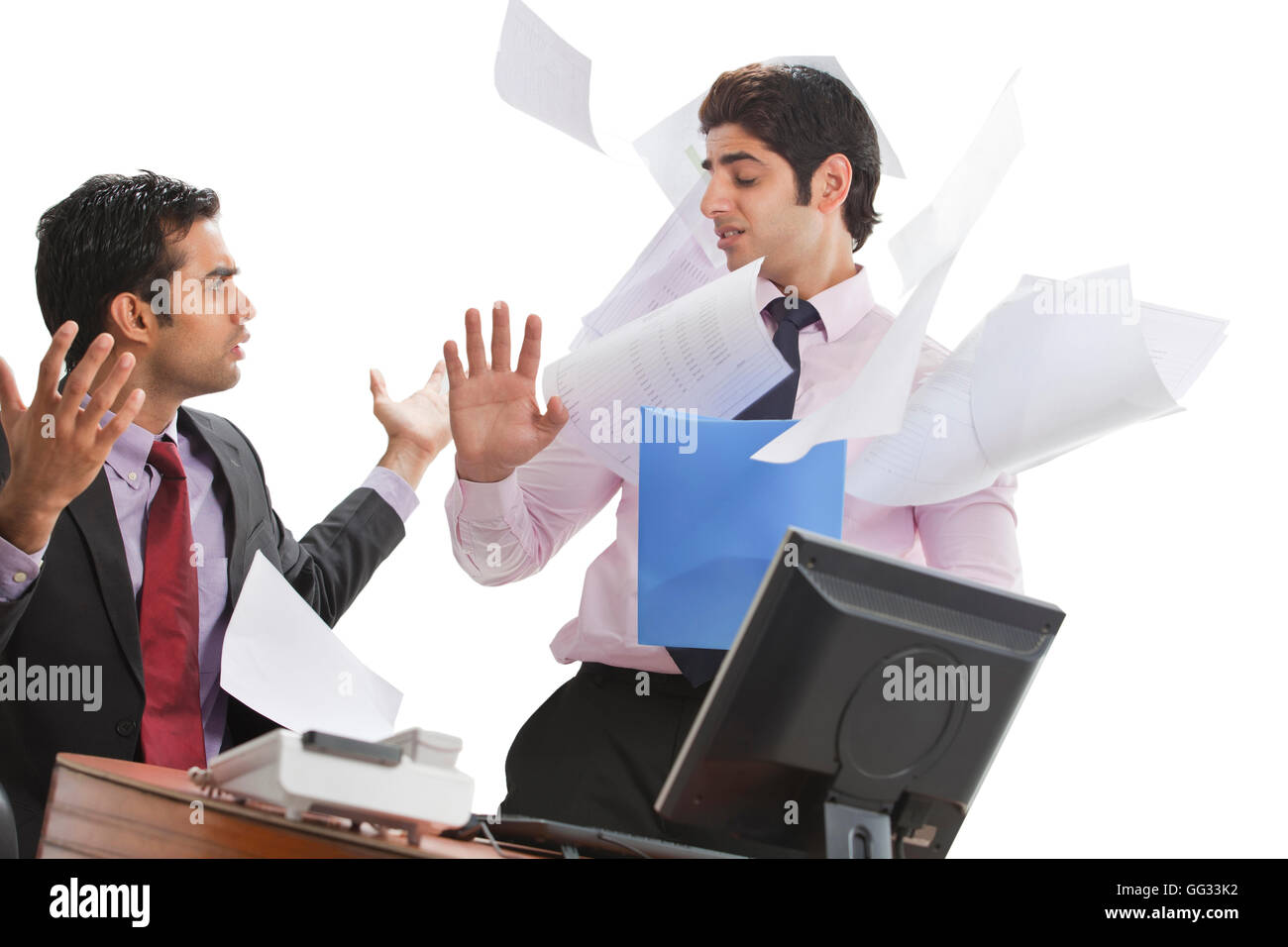 Frustrated businessman throwing papers on male executive Stock Photo ...