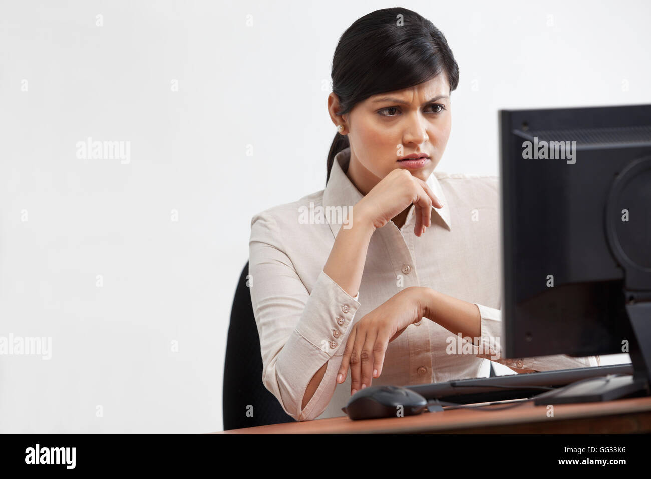 Young businesswoman looking at computer with full concentration Stock ...