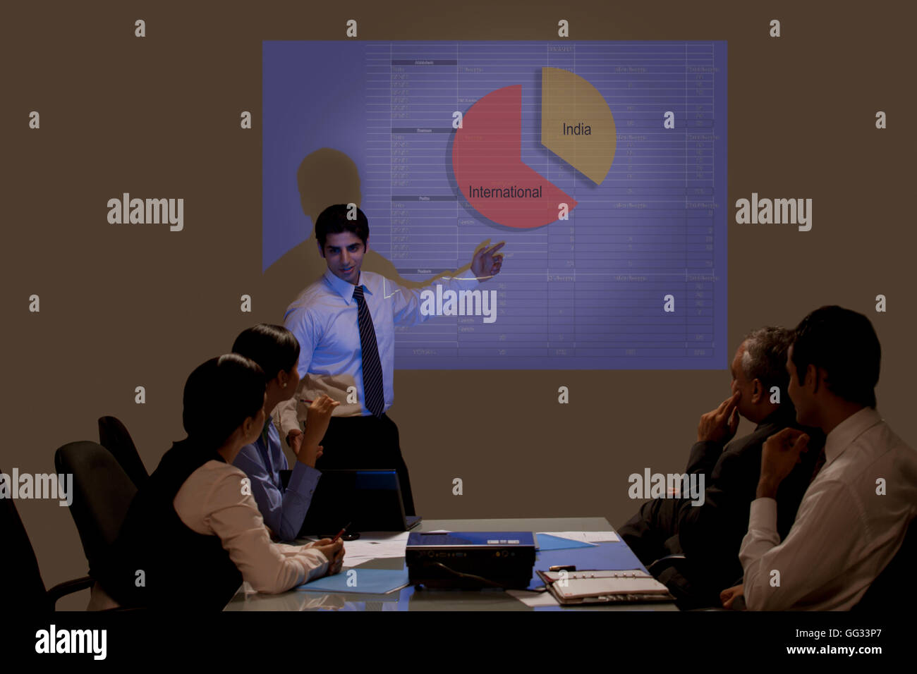 Young businessman presenting on projection screen in meeting Stock ...