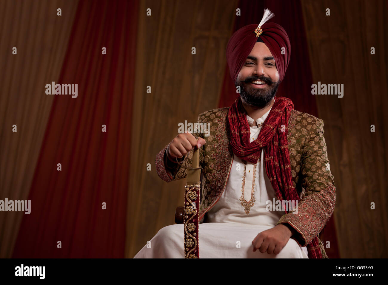 Smiling groom with sword Stock Photo - Alamy