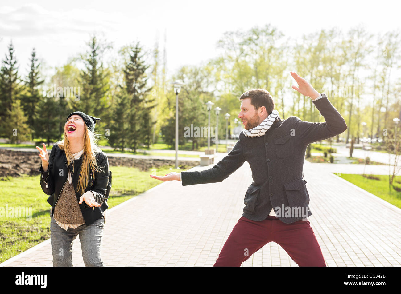 Young couple fooling around in the park Stock Photo - Alamy
