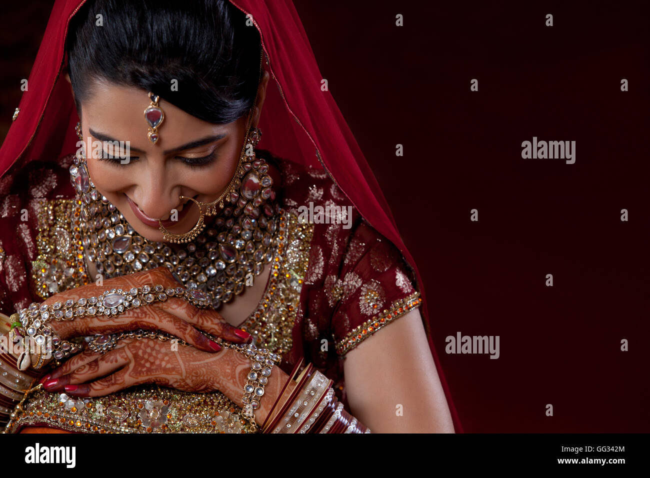 Beautiful bride looking down and smiling Stock Photo - Alamy