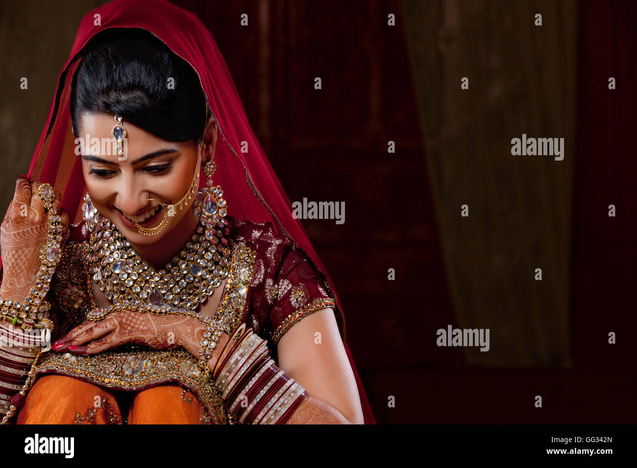 An attractive bride looking down and smiling Stock Photo - Alamy