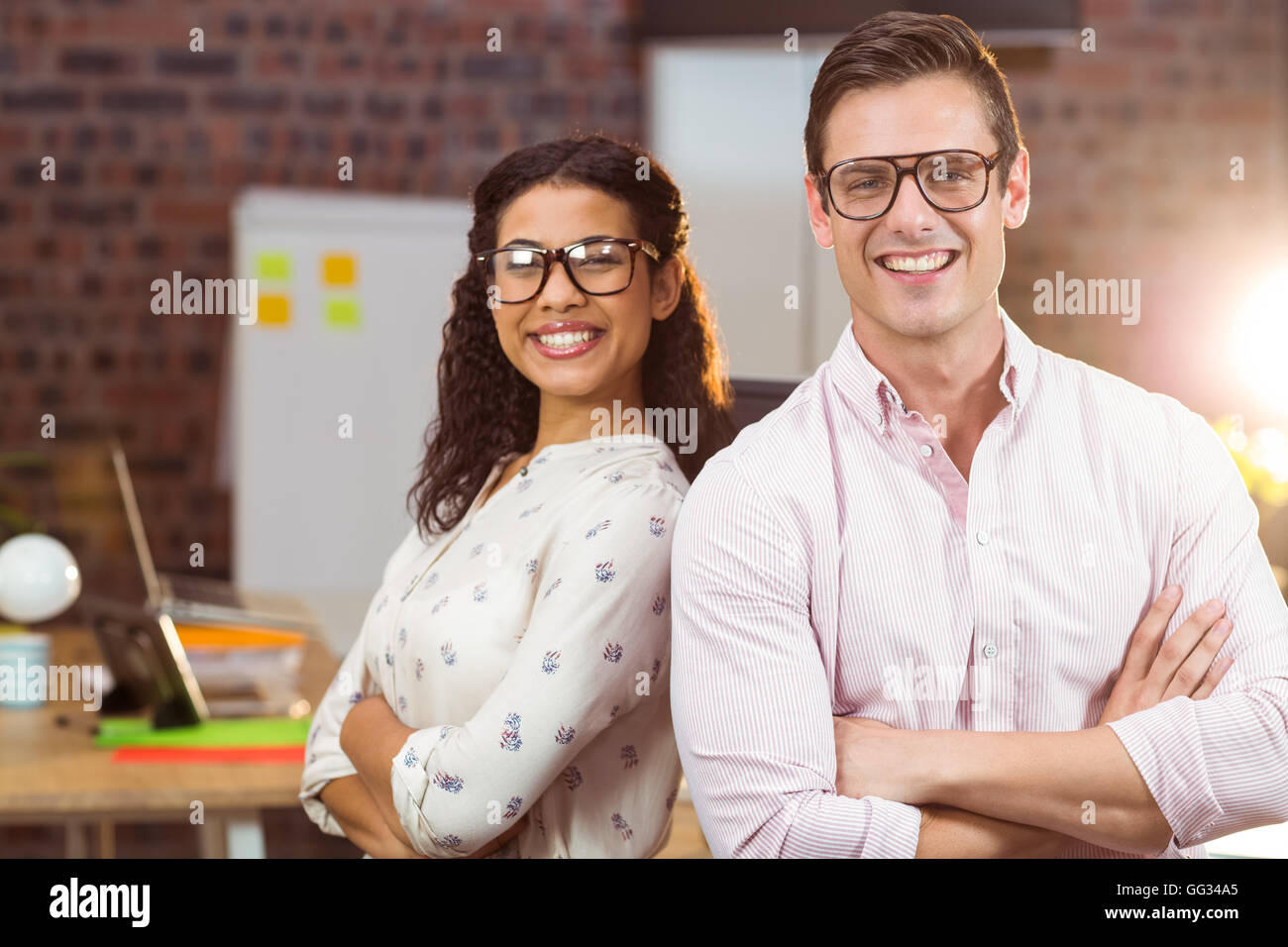 Business executives standing with arms crossed in office Stock Photo ...