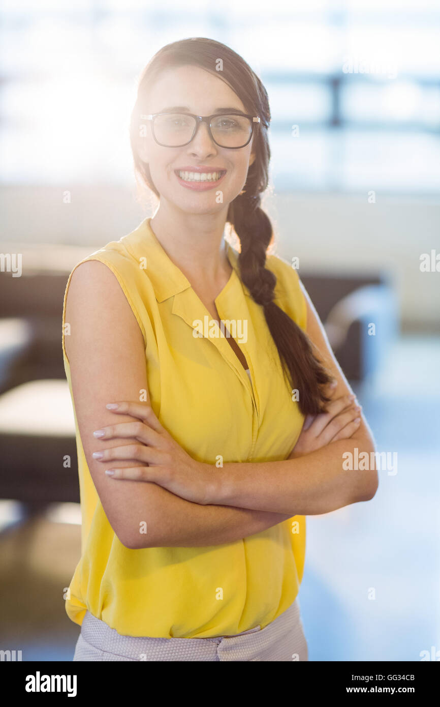 Portrait of female business executive standing with arms crossed Stock ...