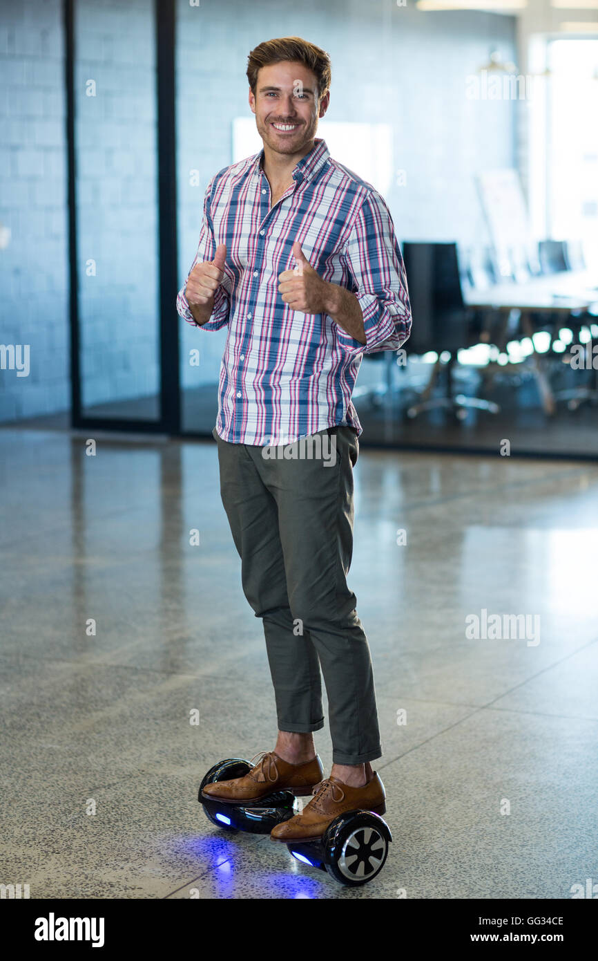 Graphic designer standing on hoverboard in office Stock Photo - Alamy