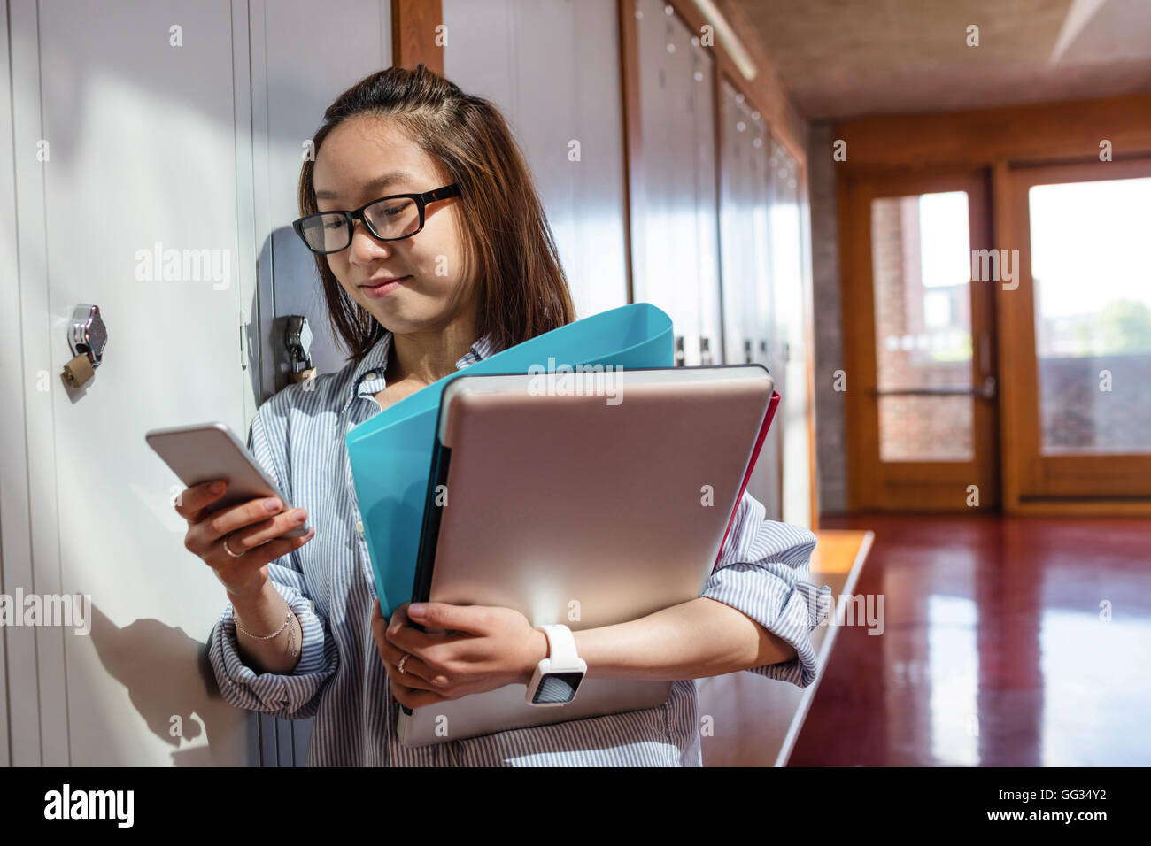 Woman standing in locker room hi-res stock photography and images - Alamy