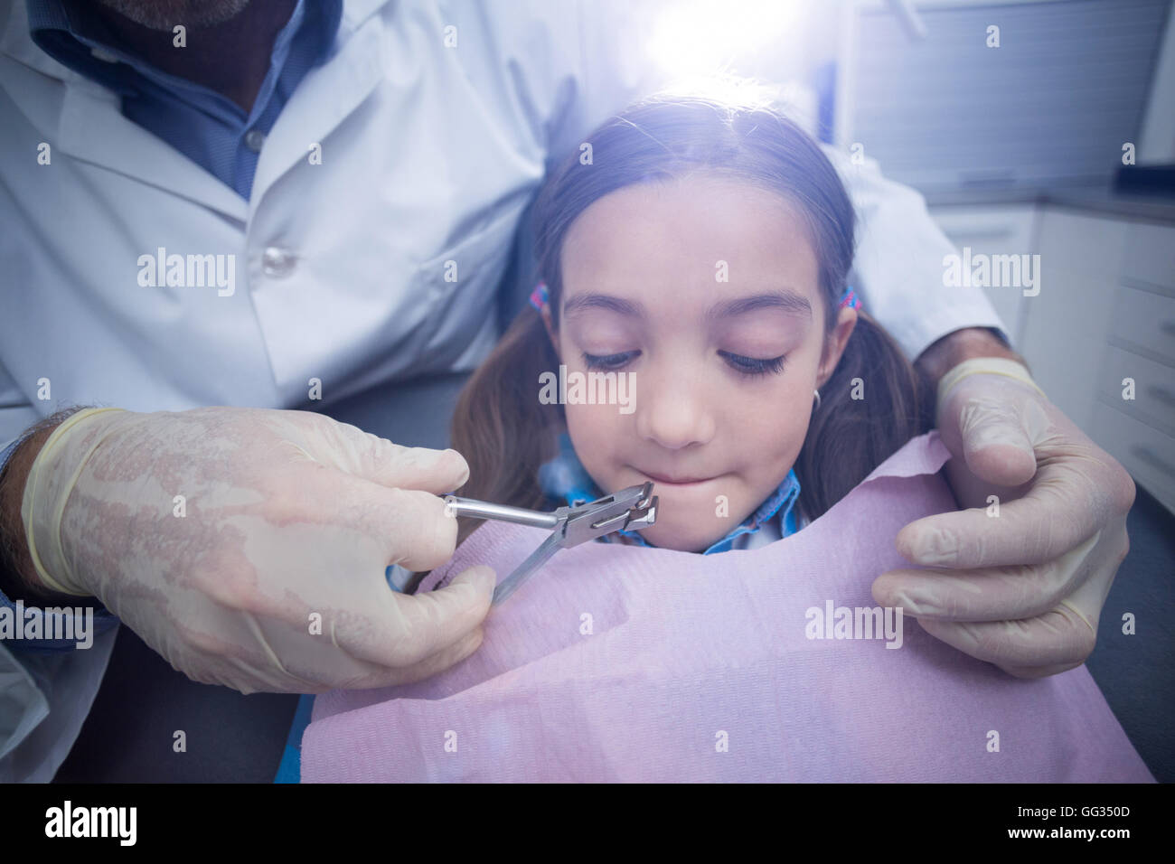 Dentist examining a young patient with tools Stock Photo - Alamy Dentist examining a young patient with tools Stock Photo - Alamy