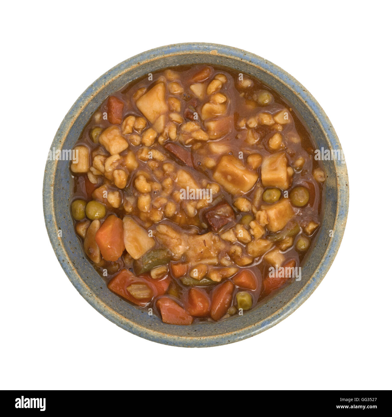 Top view of a serving of canned beef stew in an old bowl on a white ...