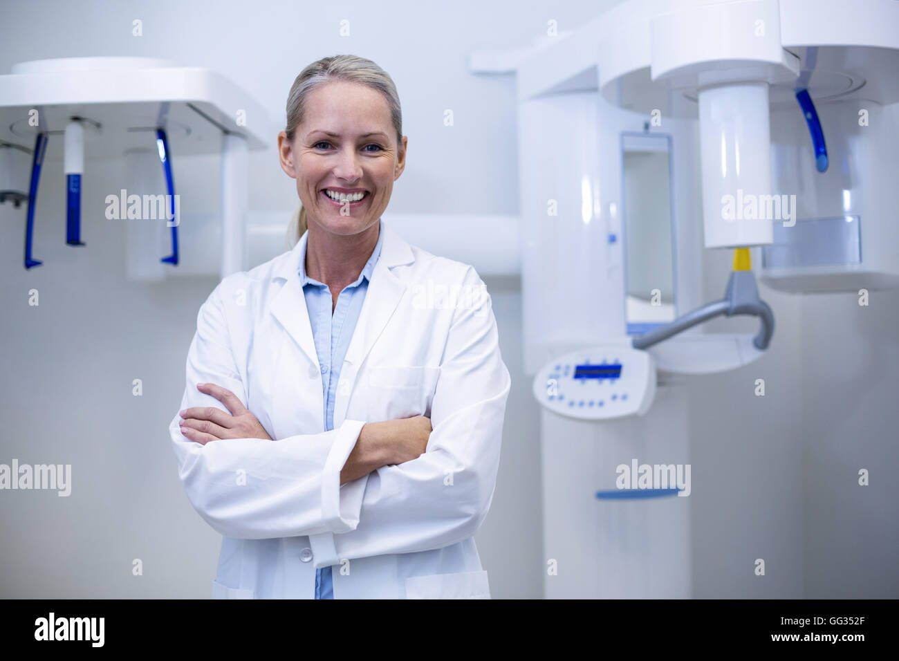 Portrait of female dentist smiling with arms crossed Stock Photo - Alamy