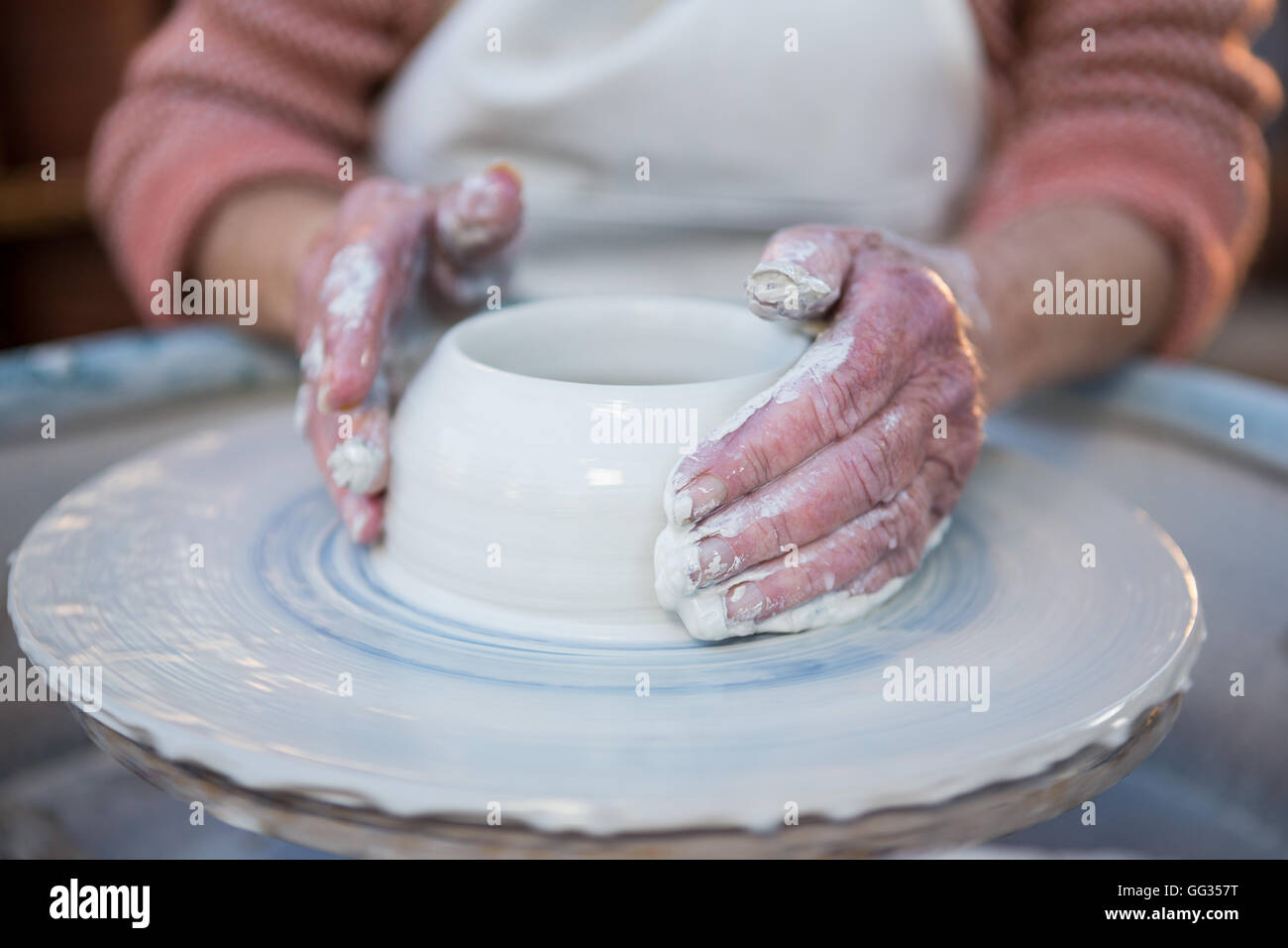 Mid section of female potter making pot Stock Photo - Alamy